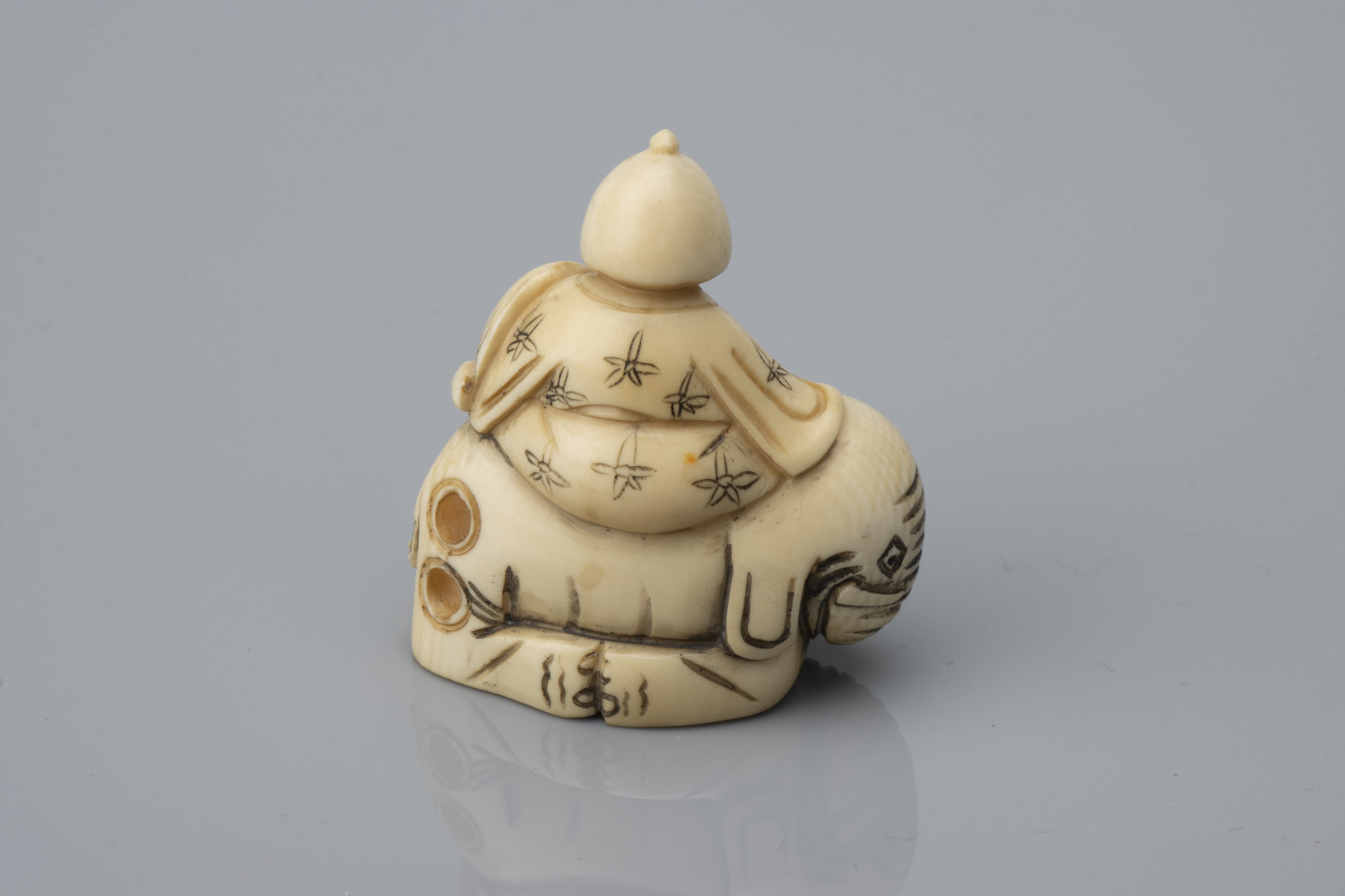 Lot 74 - A Meiji Period Ivory Netsuke of Karako on a