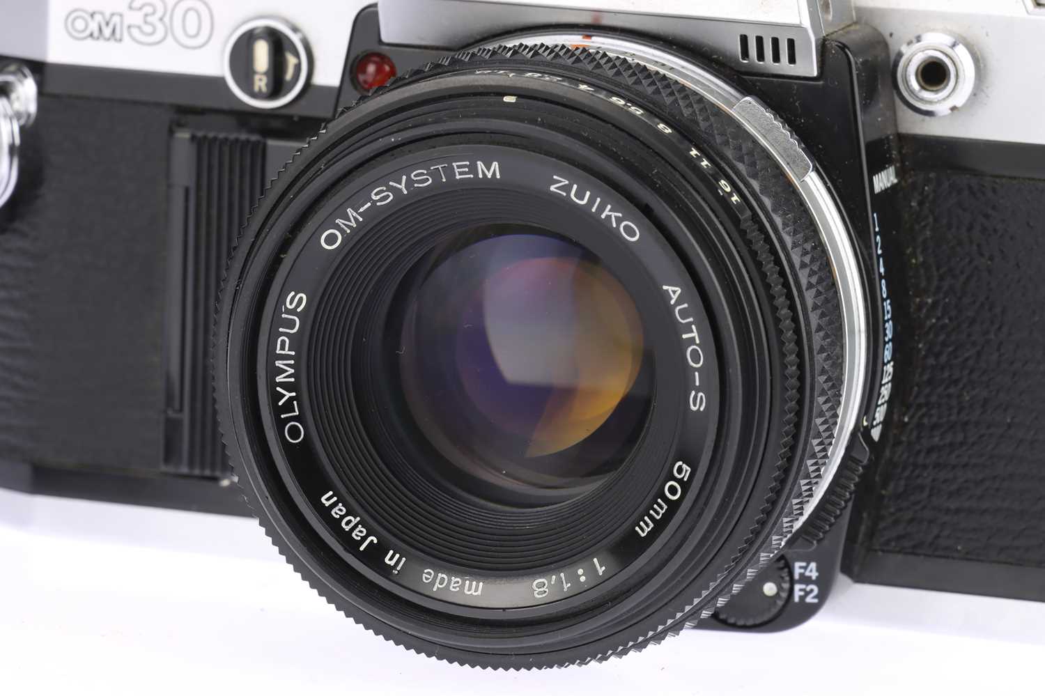 Lot 104 - Two Olympus OM Series 35mm SLR Cameras,